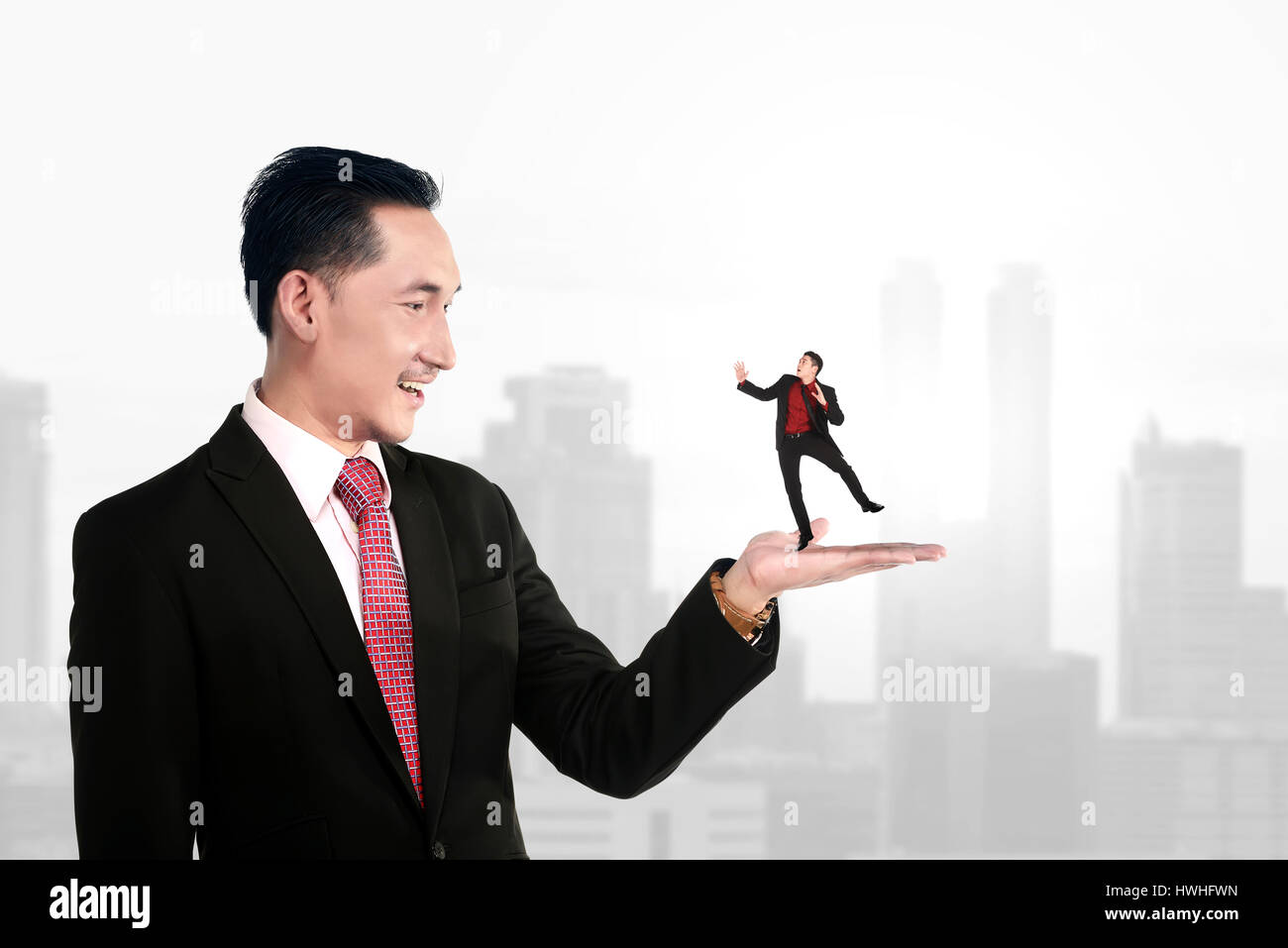 Big boss holding small subordinate, management concept Stock Photo - Alamy