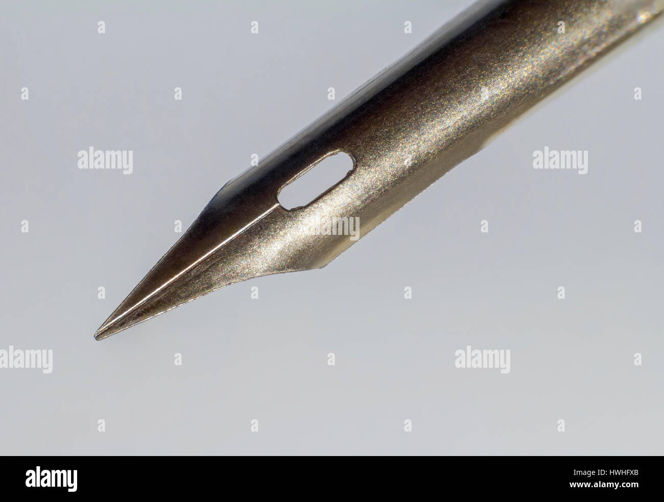 macro hot of a metallic quill tip in grey back Stock Photo - Alamy