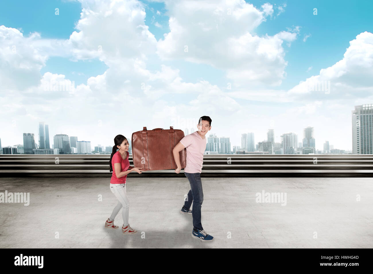 Young couple carry baggage on the city Stock Photo - Alamy
