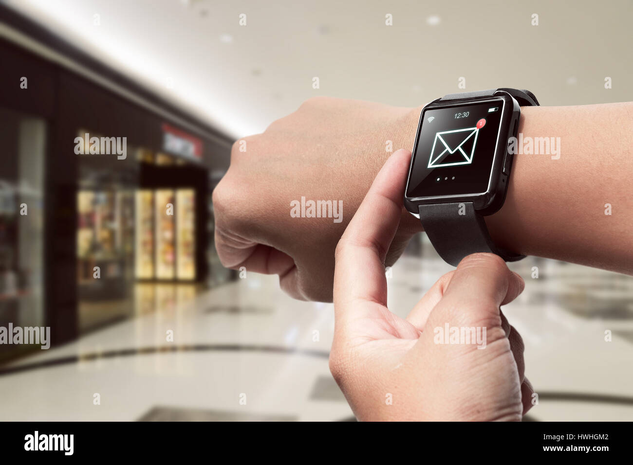 Close up smart watch with unread message icon on the screen is on hand ...
