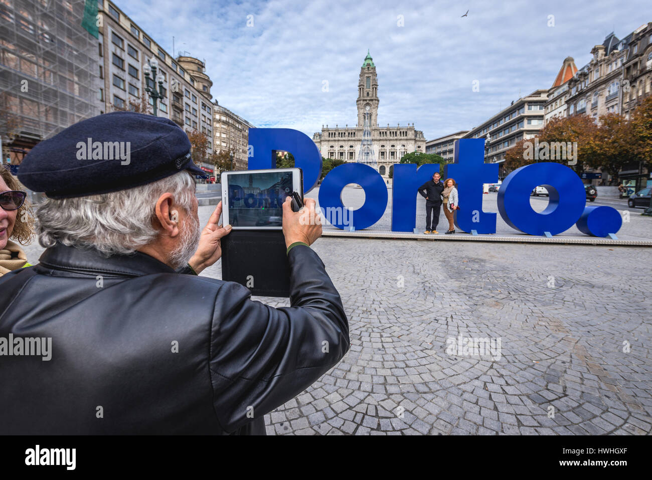 Tourists takes photos of Porto sign at Avenue of the Allies (Avenida ...
