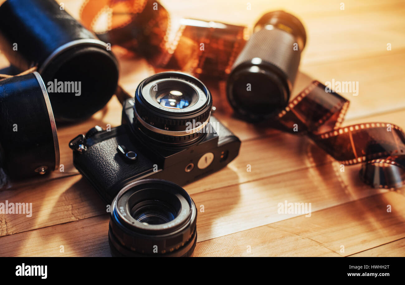 Old film camera and a roll of film on wood Stock Photo - Alamy