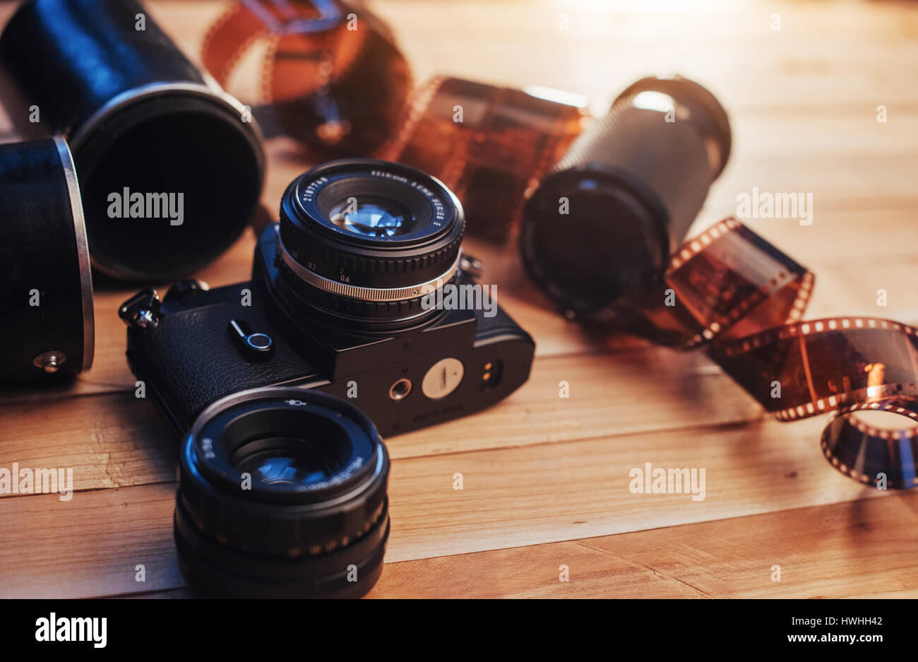 Old film camera and a roll of film on wood Stock Photo - Alamy