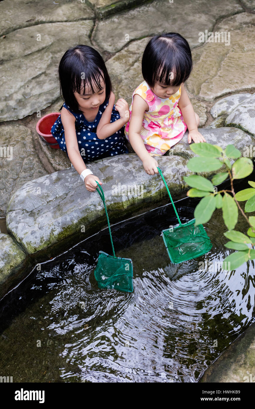 Asian children playing water outdoor hi-res stock photography and ...