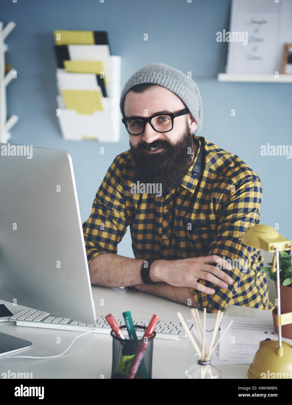 Portrait of casual man sitting at table Stock Photo - Alamy