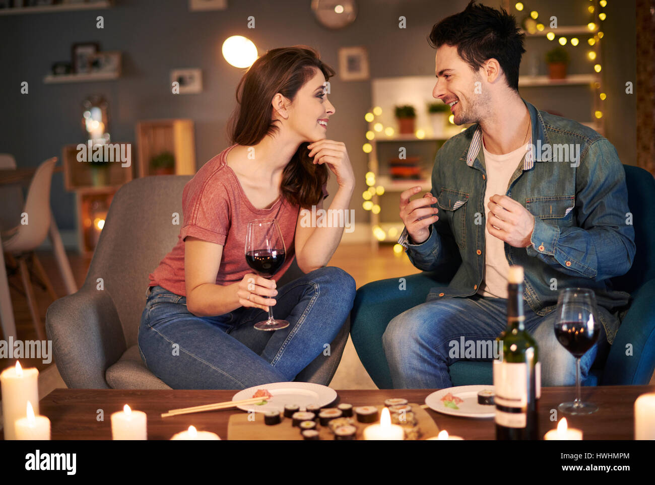 Couple enjoying evening with glass of wine Stock Photo - Alamy