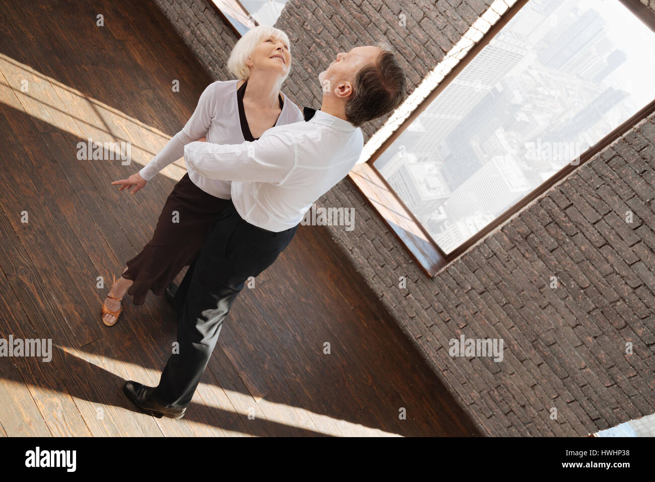 Feeling young again. Positive happy capable dance couple waltzing in ...