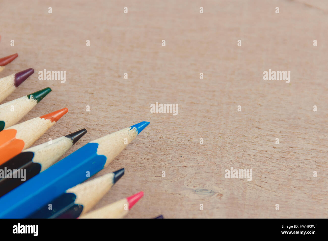 Colour pencils on wooden texture background Stock Photo - Alamy