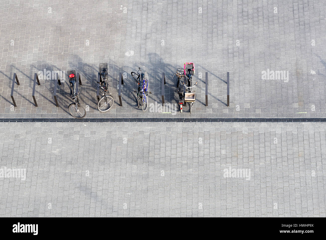 Bicycles parked on street chained to metal barriers. Top view Stock ...