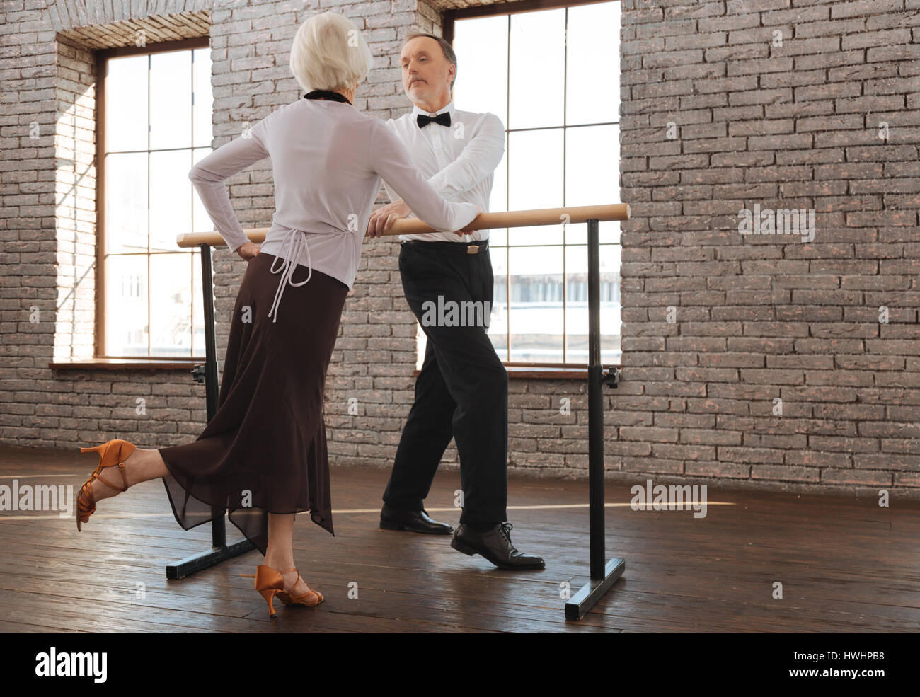 Enjoying our dance class. Positive joyful aging couple dancing in the ...