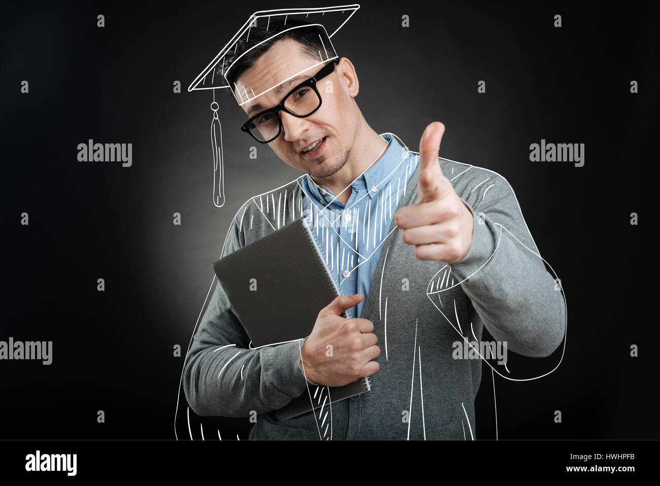 Great result. Pleasant successful graduate holding textbook and ...