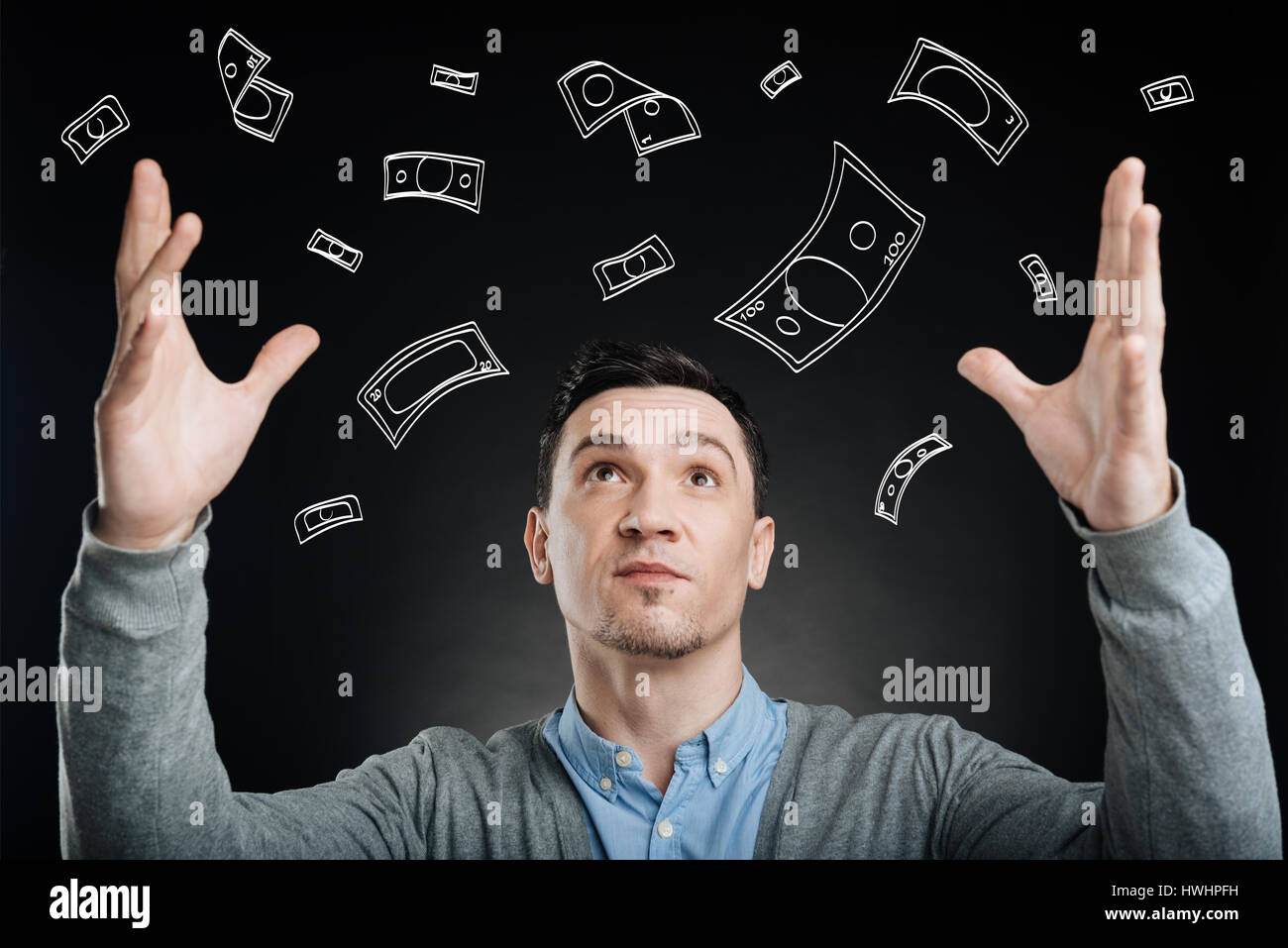 Earn as much as you can. Concentrated rich man enjoyign money rain and ...