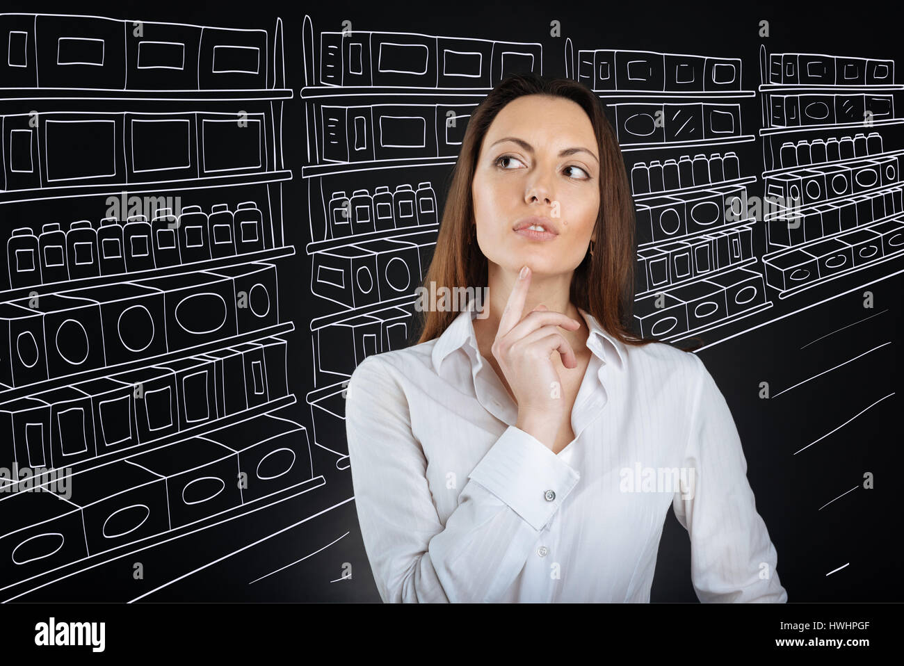 Difficult choise. Concentrated beautiful woman shopping in a ...