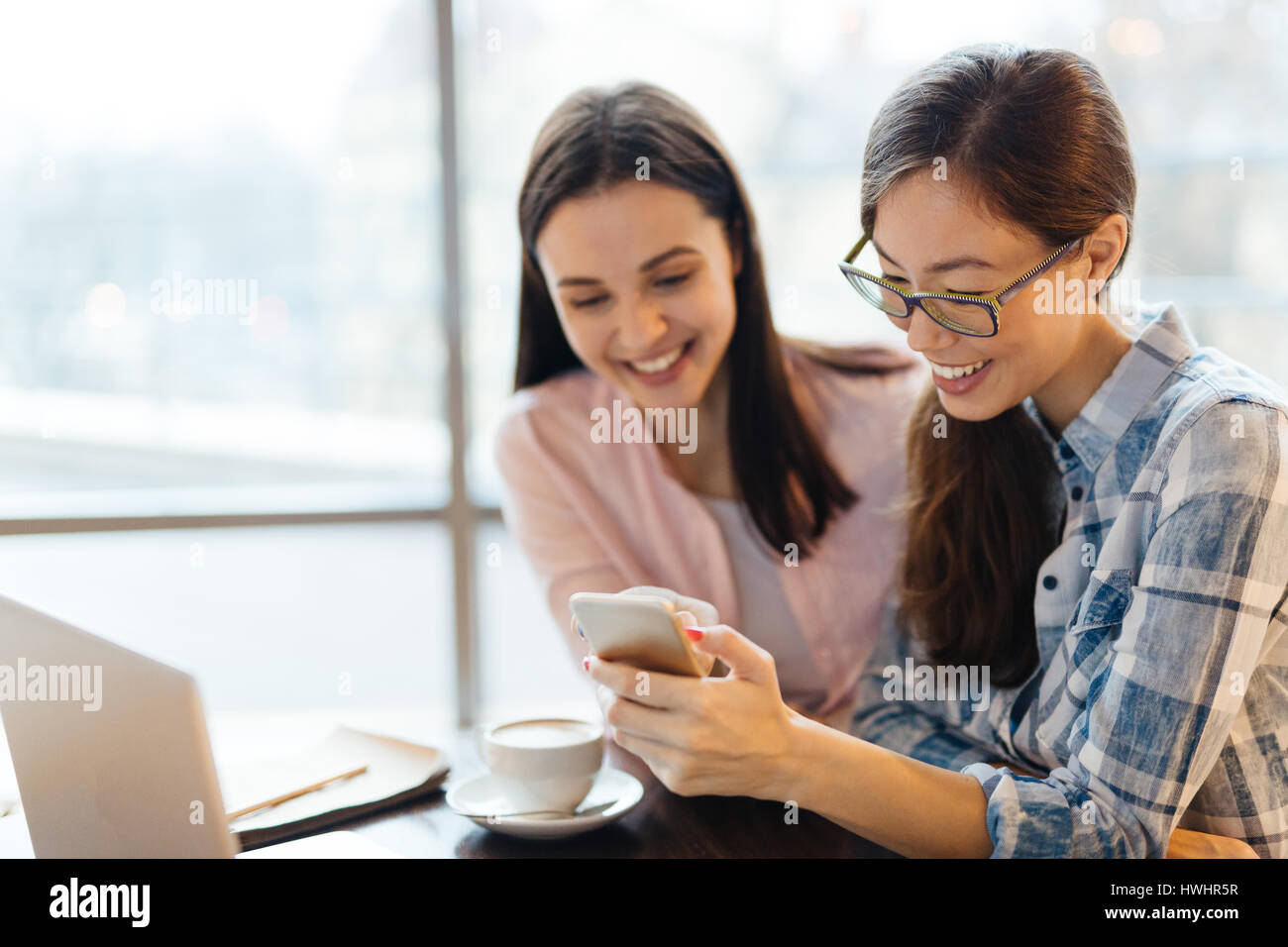 Happy girls addicted to gadgets reading sms in smartphone Stock Photo ...