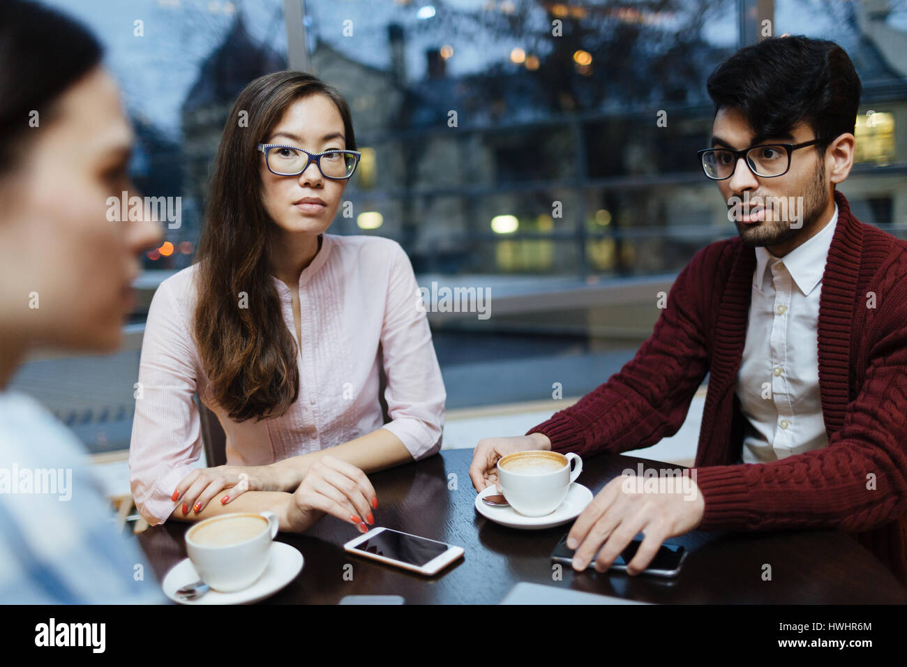 Modern managers having conversation in cafe after work Stock Photo - Alamy