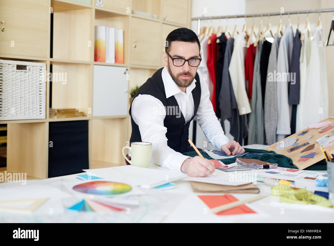 Creative designer sketching fashion models in his studio Stock Photo ...