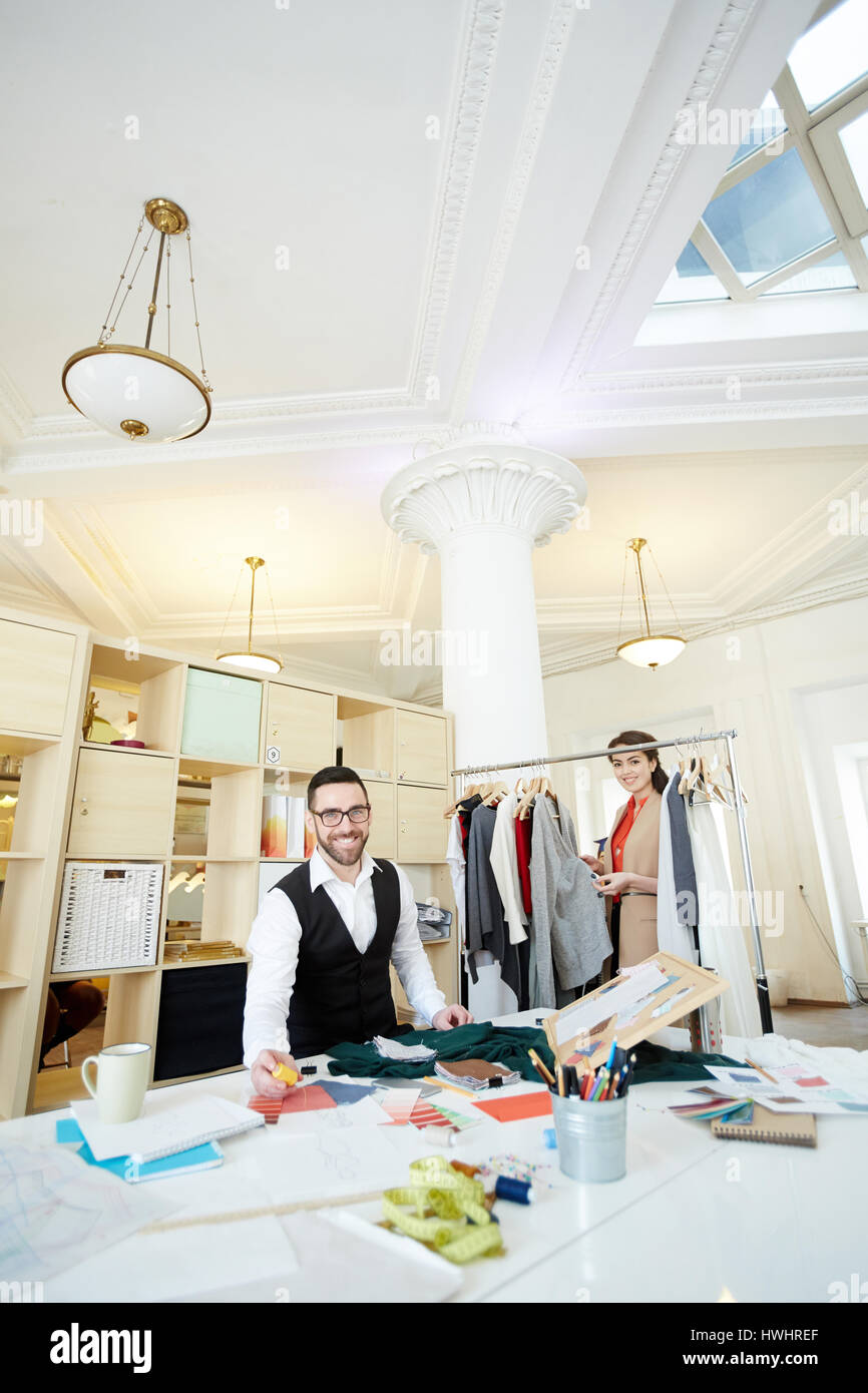 Small group of fashion designers working in atelier Stock Photo - Alamy