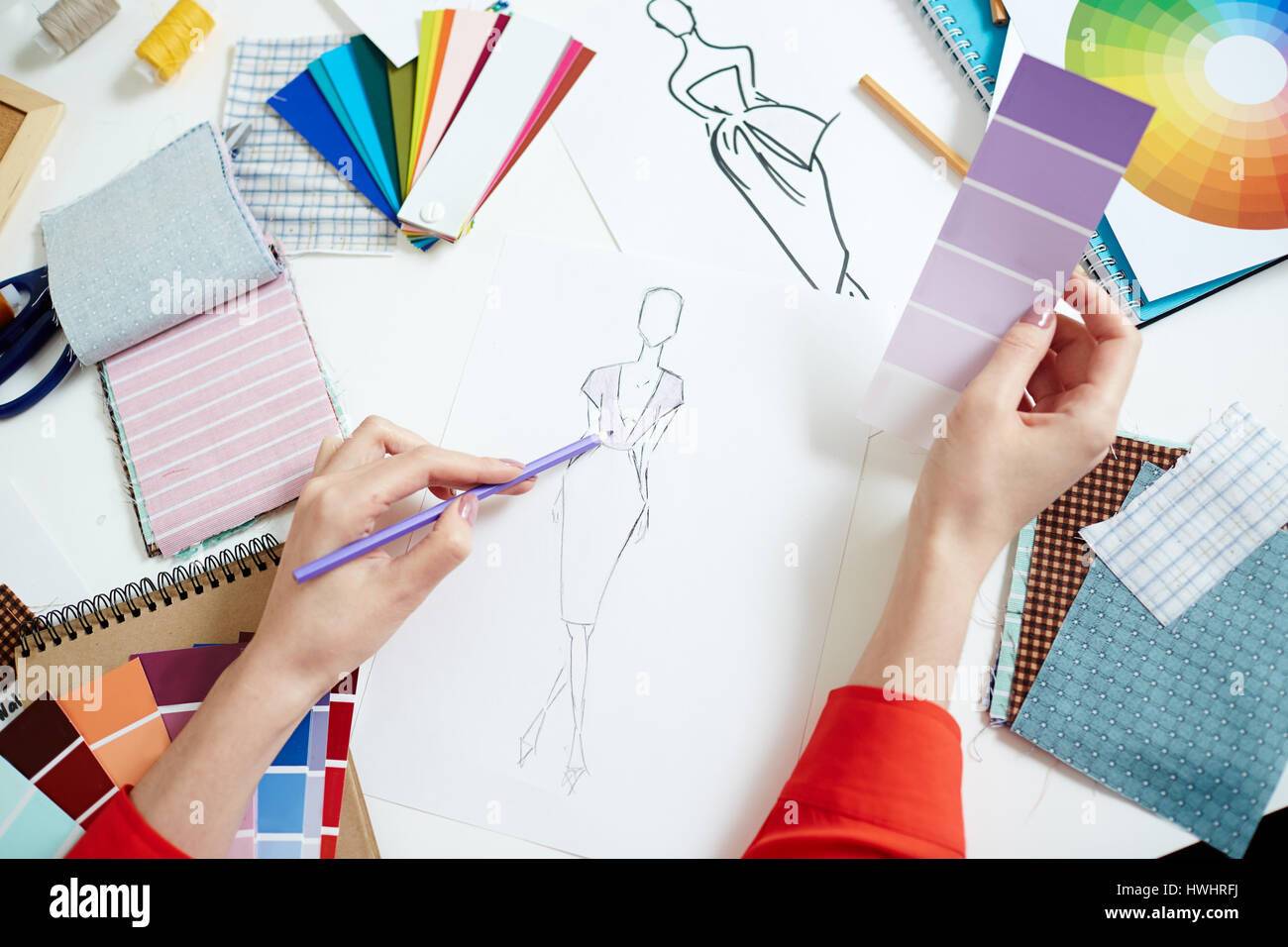 Fashion designer sketching new creative clothes Stock Photo - Alamy