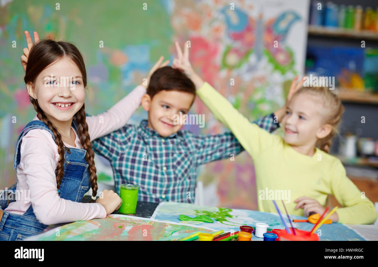 Smiling kids having fun at drawing lesson Stock Photo - Alamy