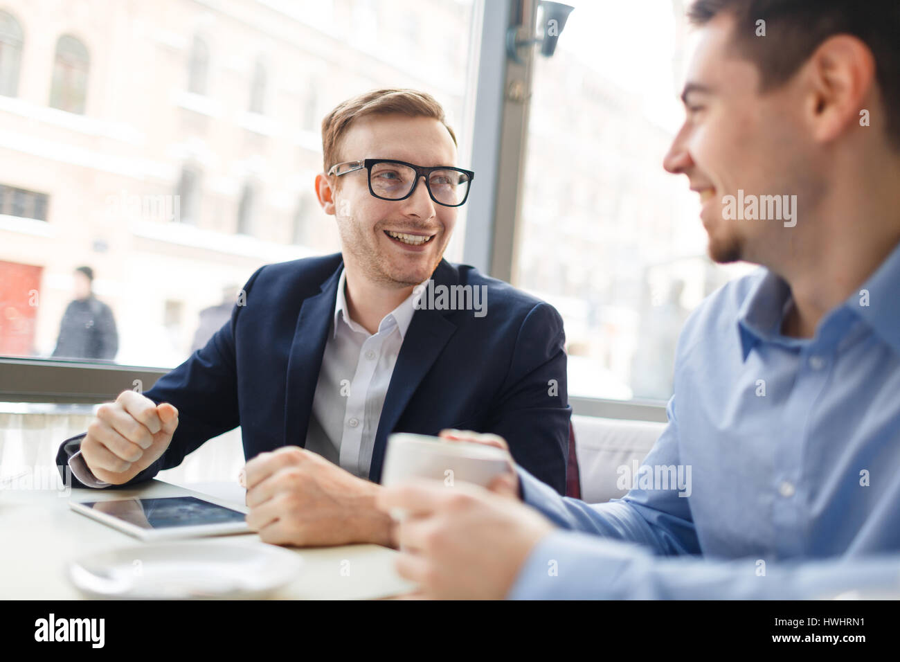 Successful trader explaining his colleague how to increase sales level ...
