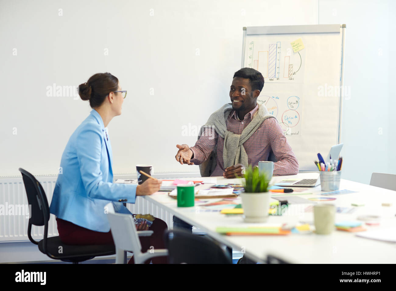 Young man explaining something to his colleague or groupmate Stock ...