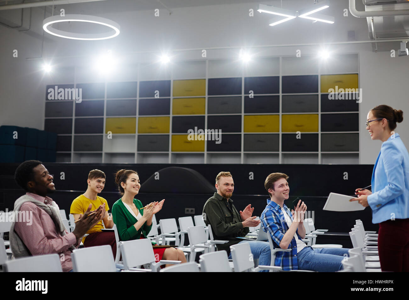Happy students applauding to speaker after listening to her report ...