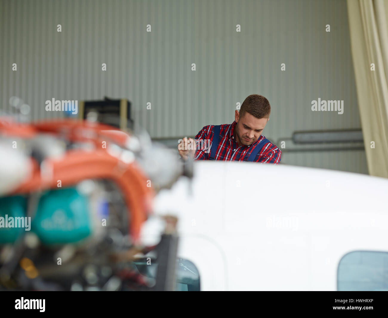 Technician repairing engine of jet before season of flights Stock Photo ...