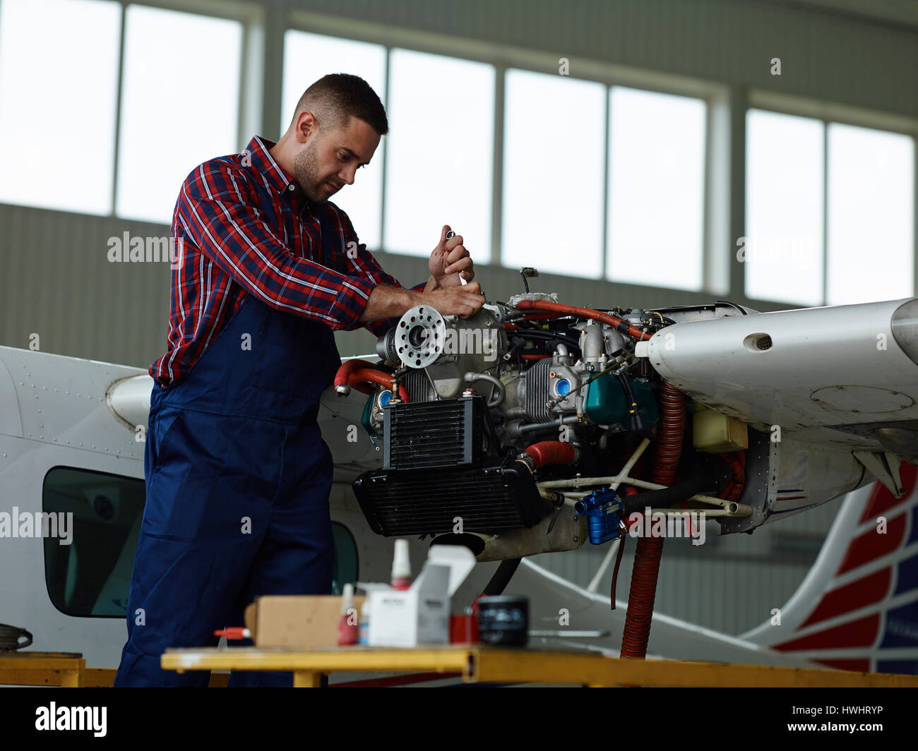 Technical worker repairing motor of jet before flight season Stock ...