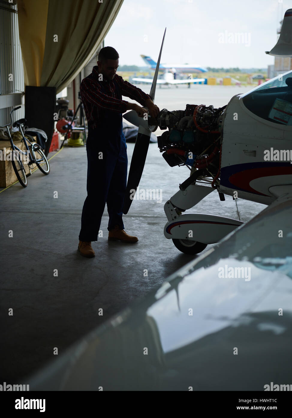 Troubleshooting service worker repairing turbine of airplane Stock ...