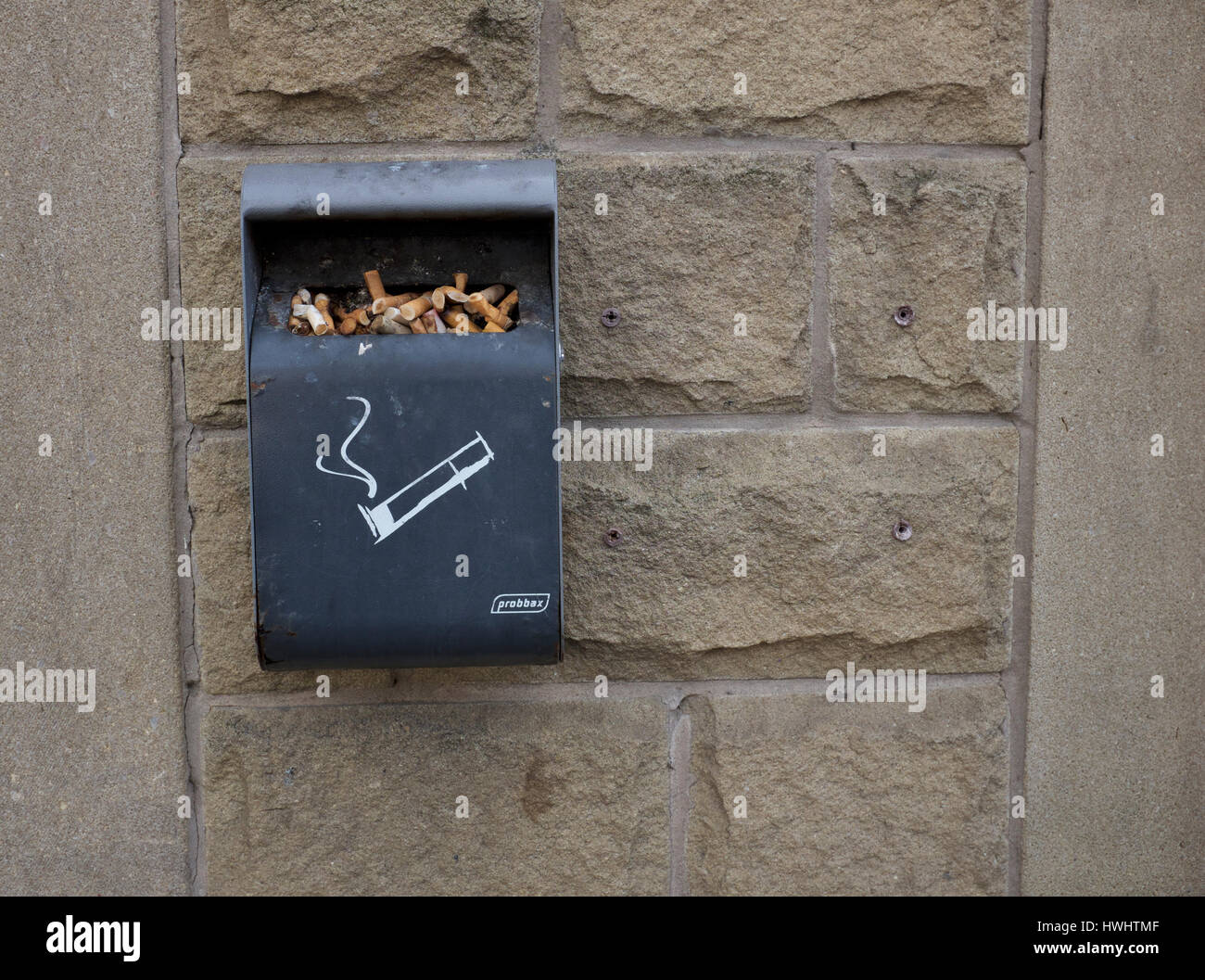 A full cigarette butt box on a wall in New Mills, High Peak, Derbyshire ...