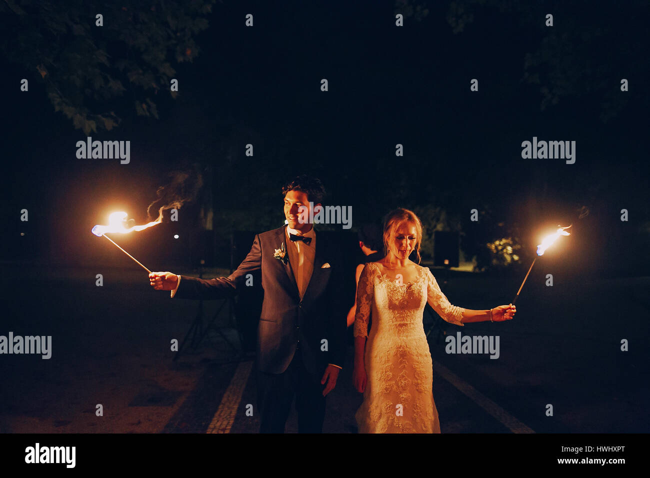the bride and groom light a fire heart Stock Photo - Alamy