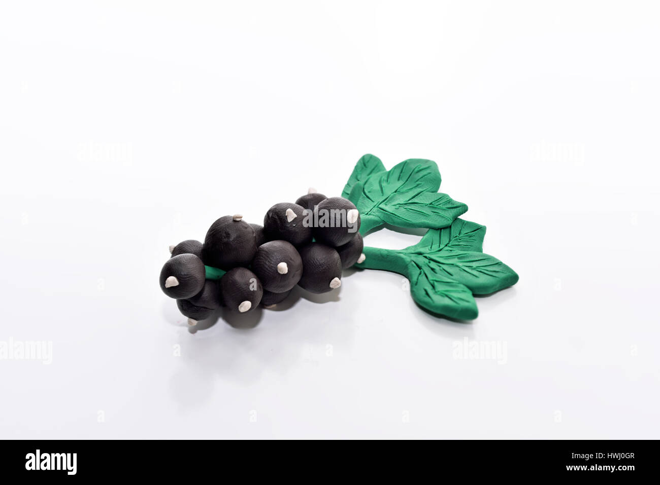 Black currant made from plasticine. Isolated on white background Stock ...