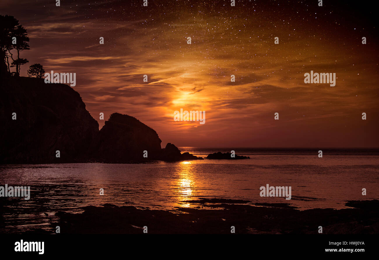 Coastal sunset deep reds Stock Photo - Alamy