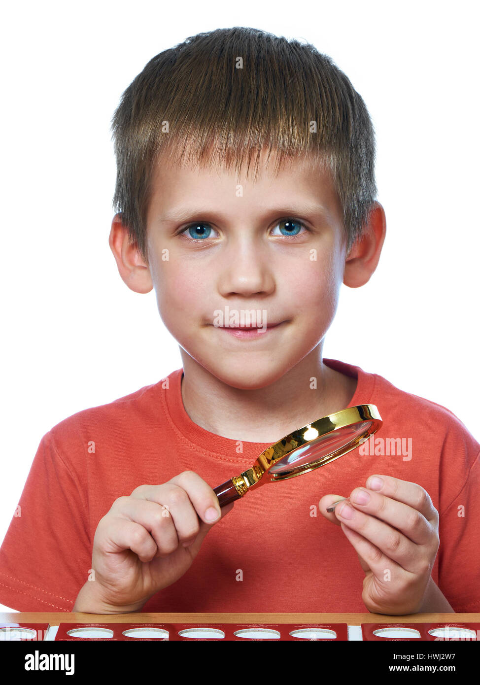 Boy with coin and magnifying glass isolated white Stock Photo - Alamy