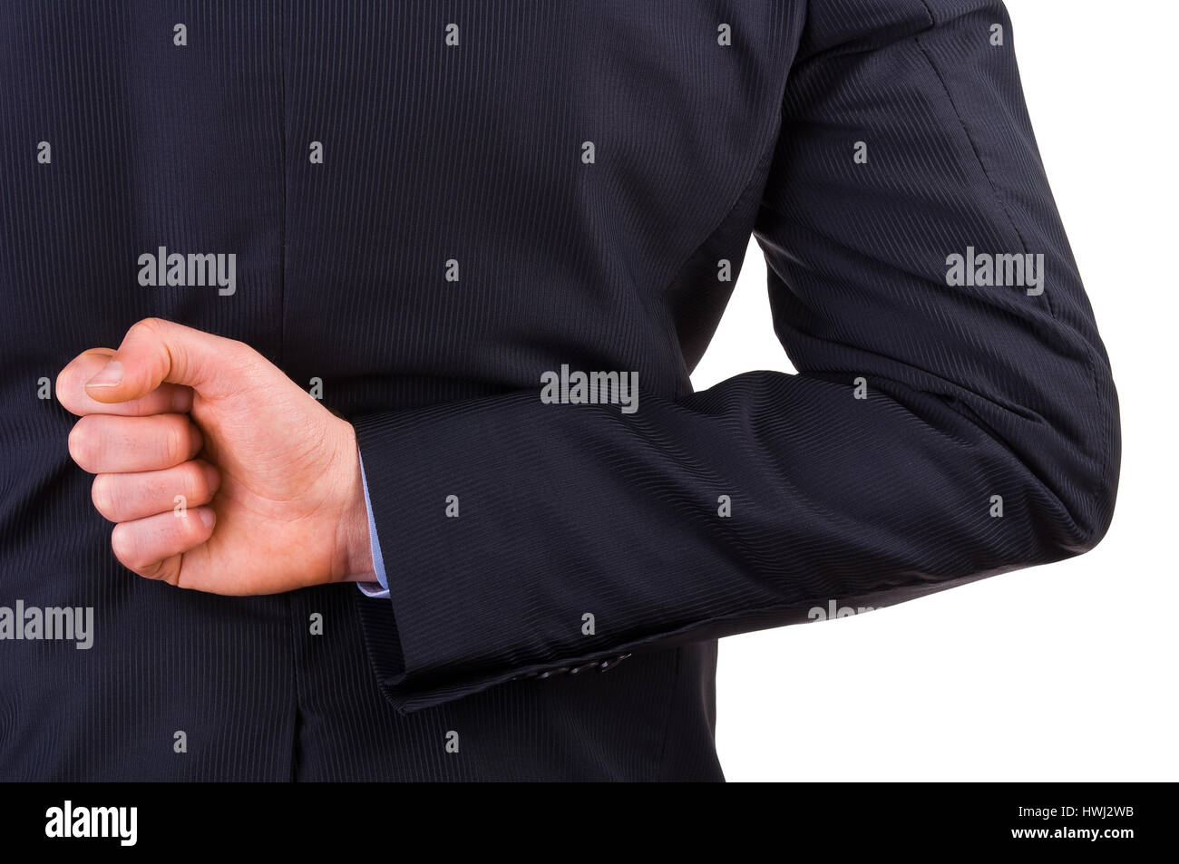 Businessman with his hand behind his back Stock Photo - Alamy