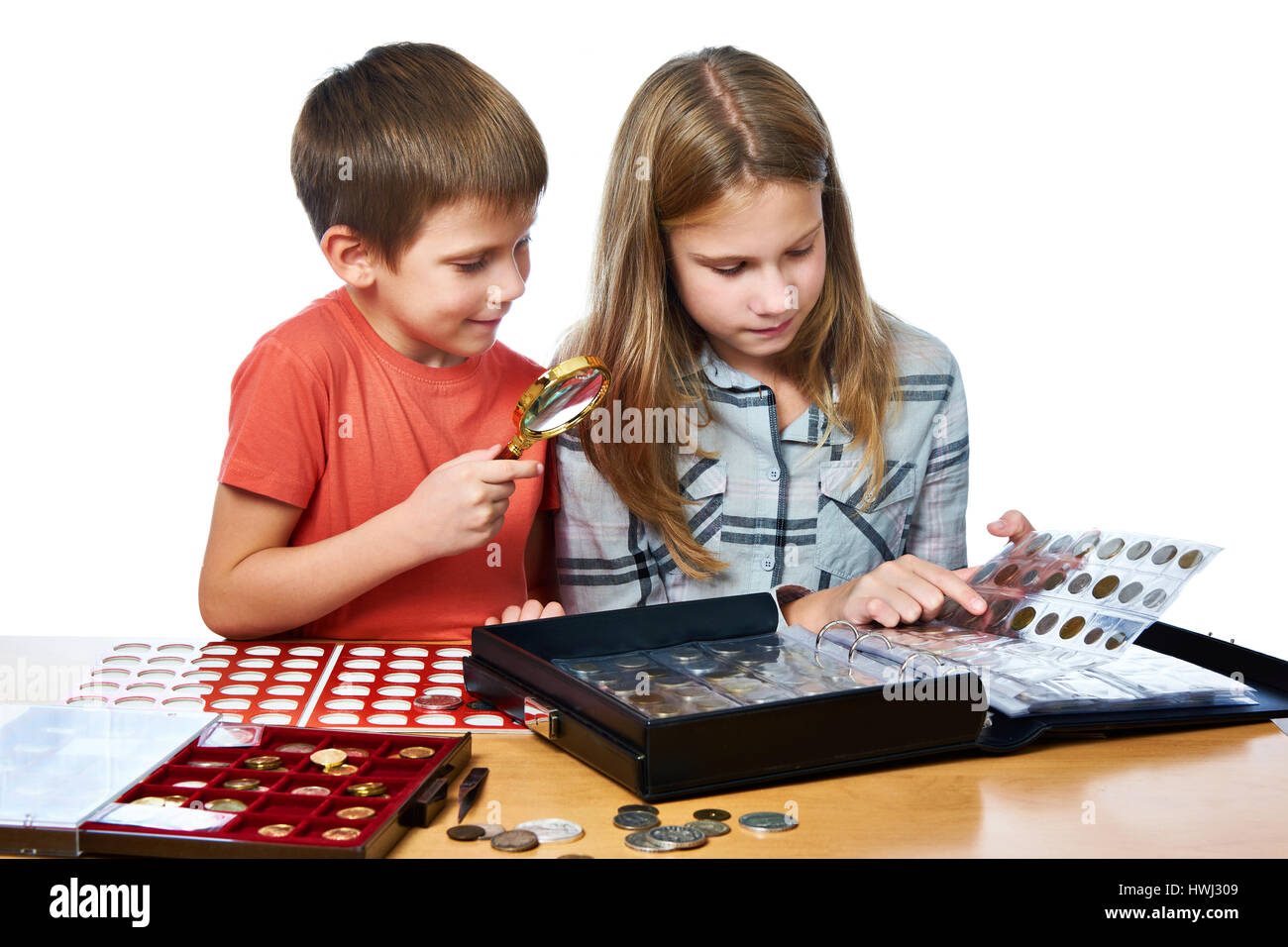 Boy and girl are considering coin collection isolated white Stock Photo ...