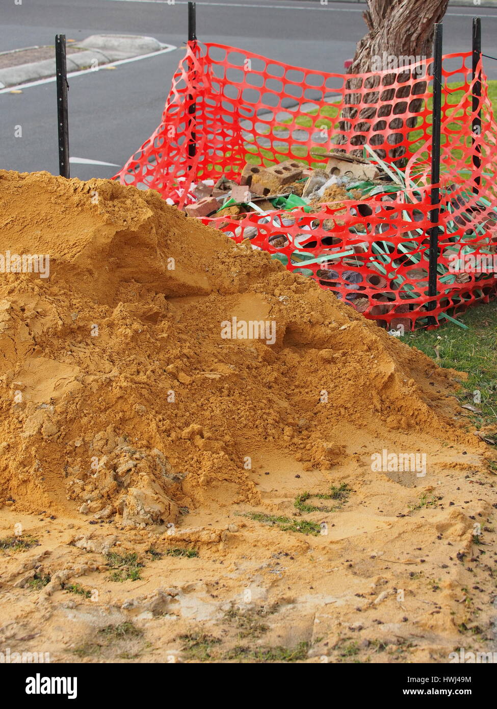 Sand a security fencing at a building site Stock Photo - Alamy