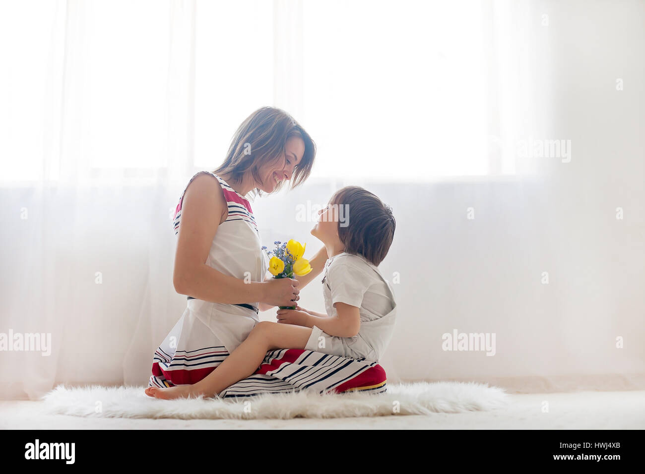 Mother and her child, embracing with tenderness and care, child giving ...