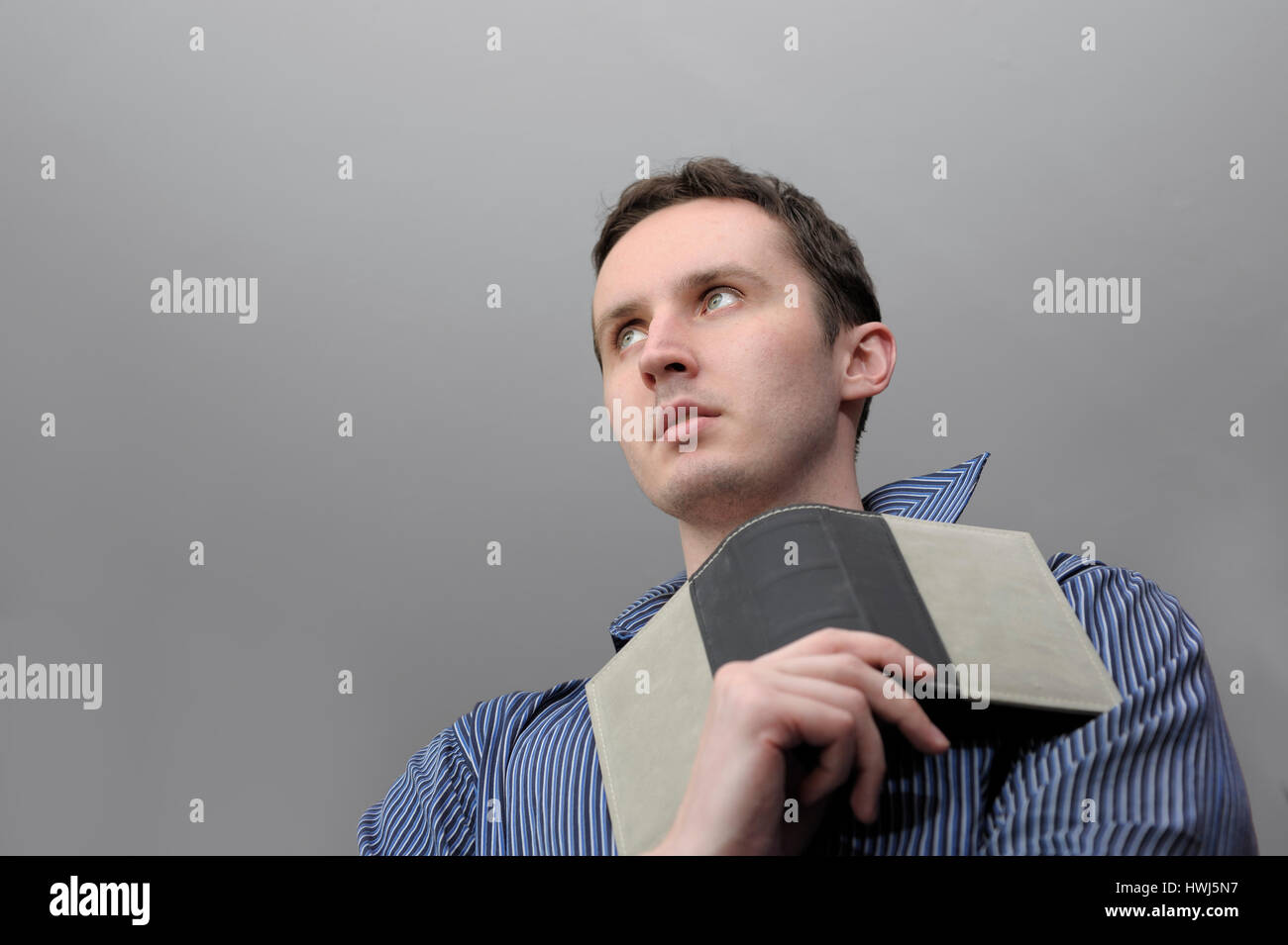 Man reading book over grey background Stock Photo - Alamy