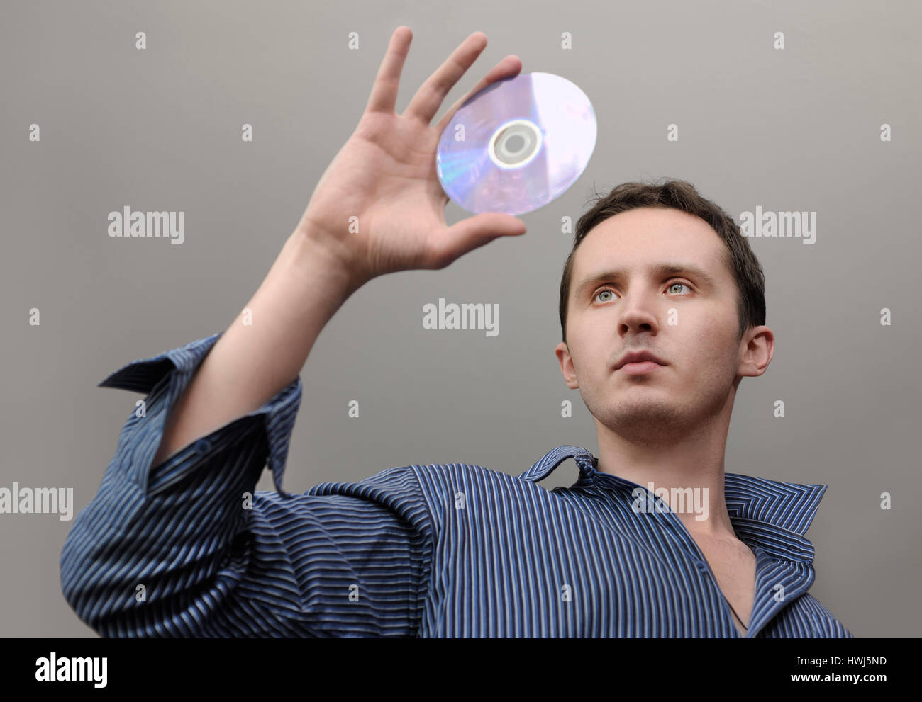 Man with compact disc in hand Stock Photo - Alamy