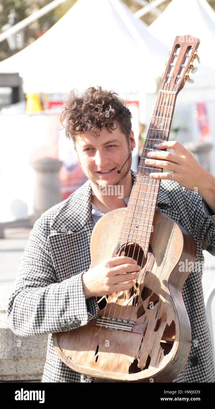 male busker playing guitar and singing Stock Photo - Alamy