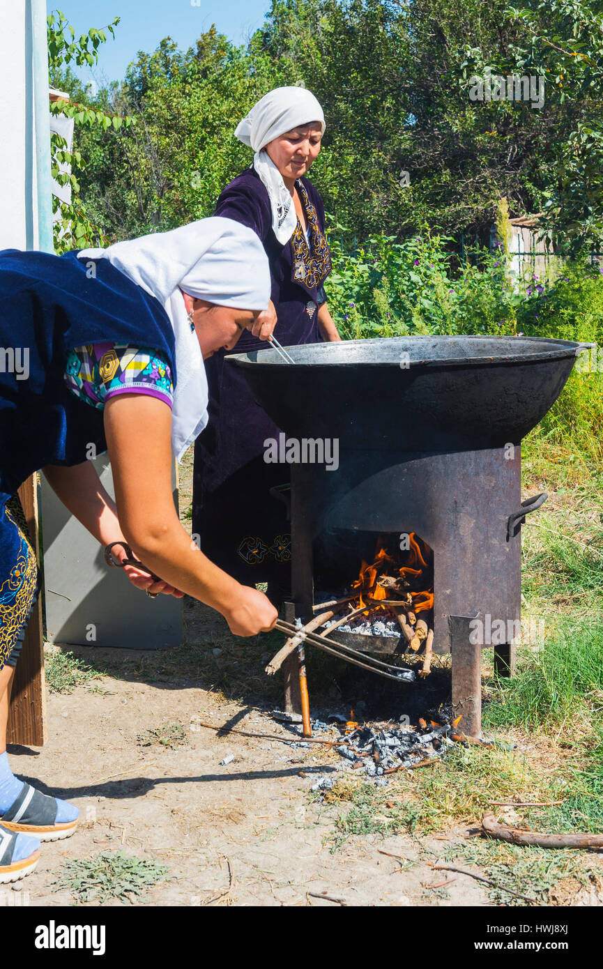 Kazakh Woman preparing the traditional local tandyr bread, Shymkent ...