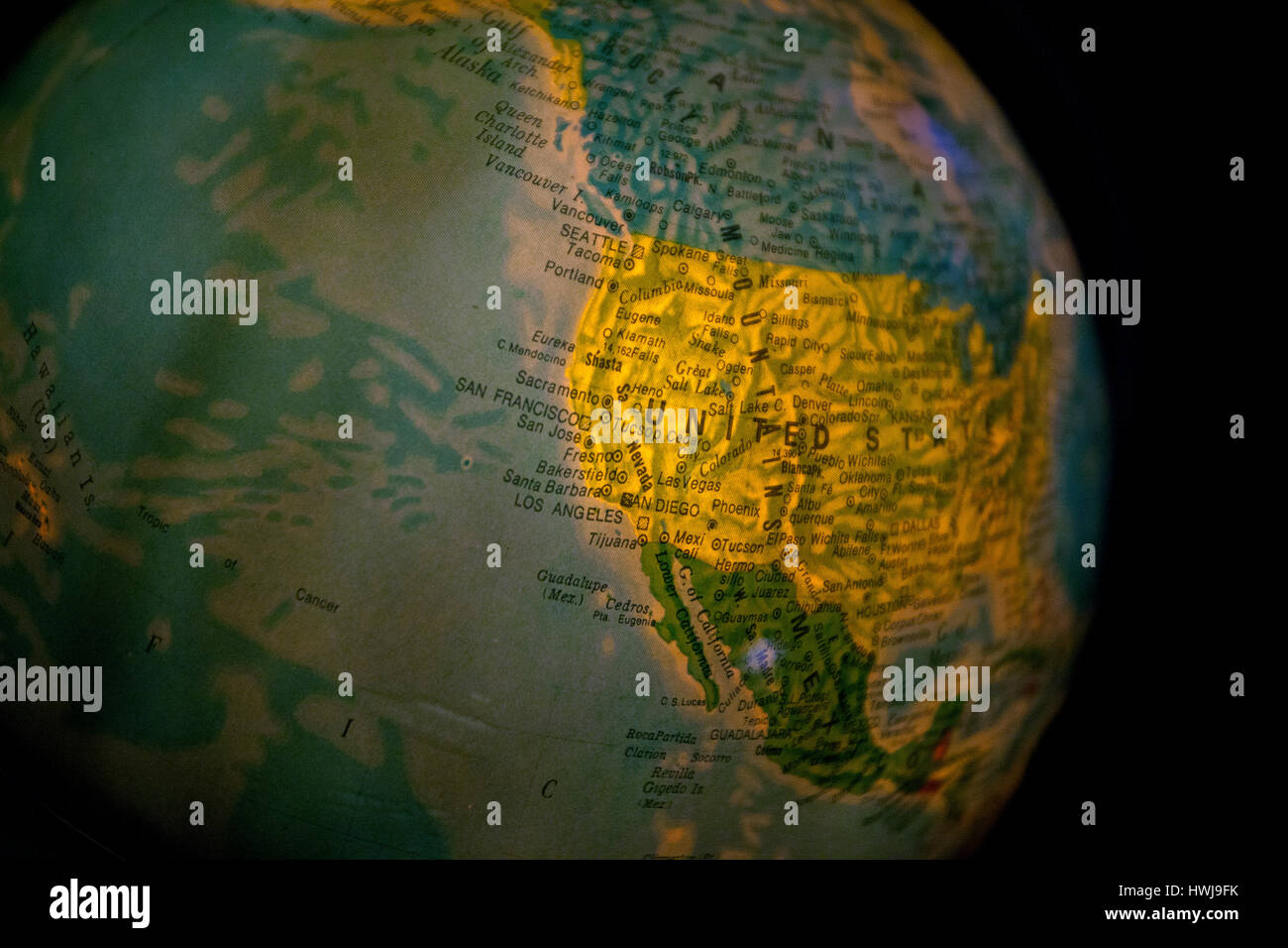 close up of old fashioned world globe a ball shaped map lit from within ...