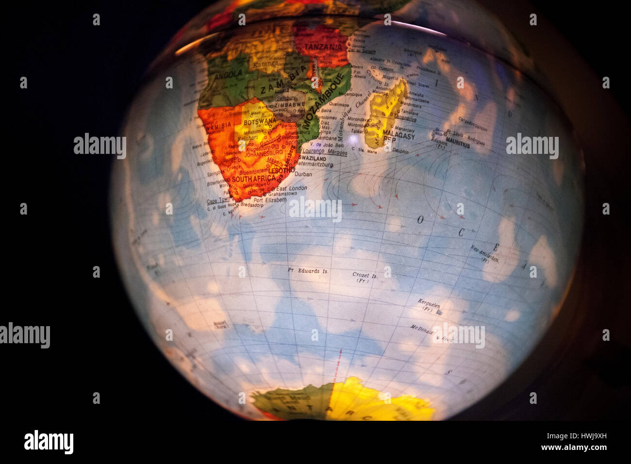 close up of old fashioned world globe a ball shaped map lit from within ...