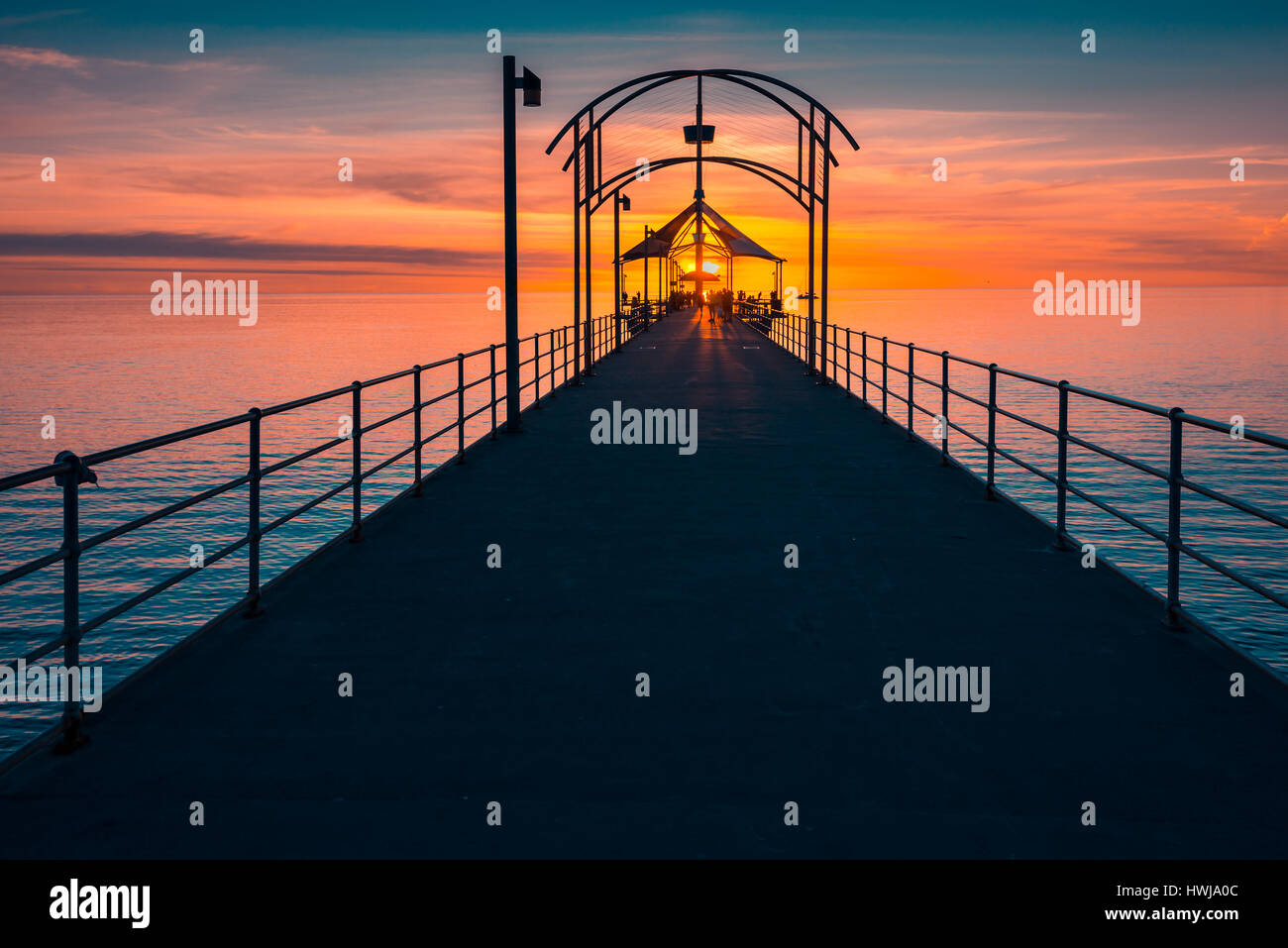 People walking along Brighton Jetty at sunset Stock Photo - Alamy