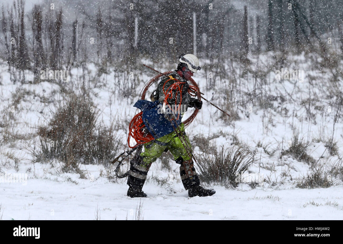 A Scottish Power engineer walks through snowy conditions to restore ...