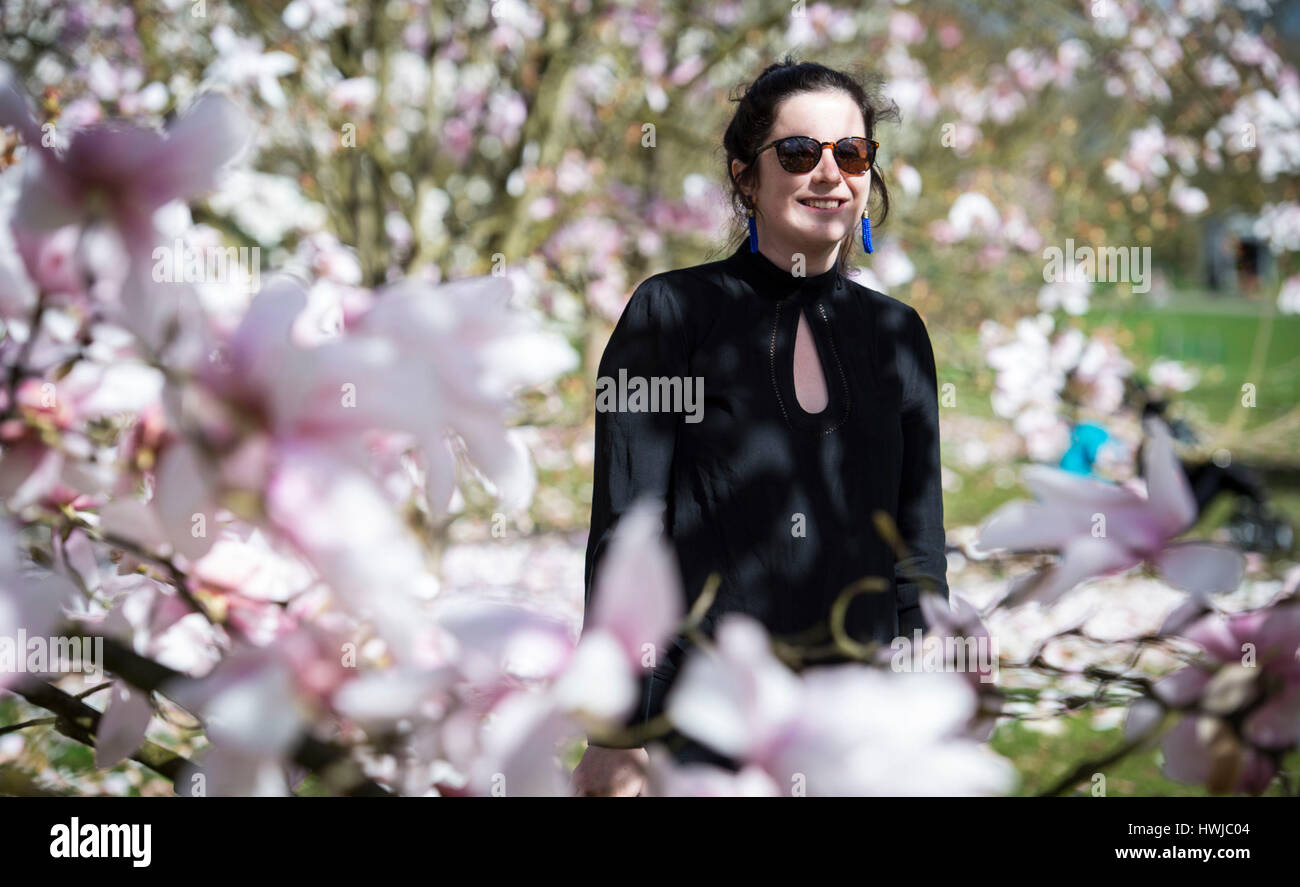 A visitor looks at a cherry blossom tree in Kew Gardens, south-west ...