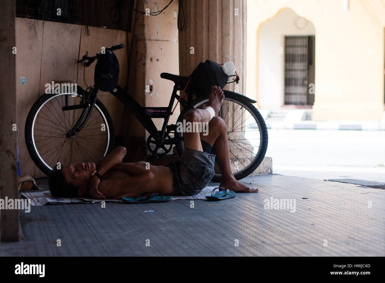 Tired asiat man sleep and relax near bicycle on the floor Stock Photo ...