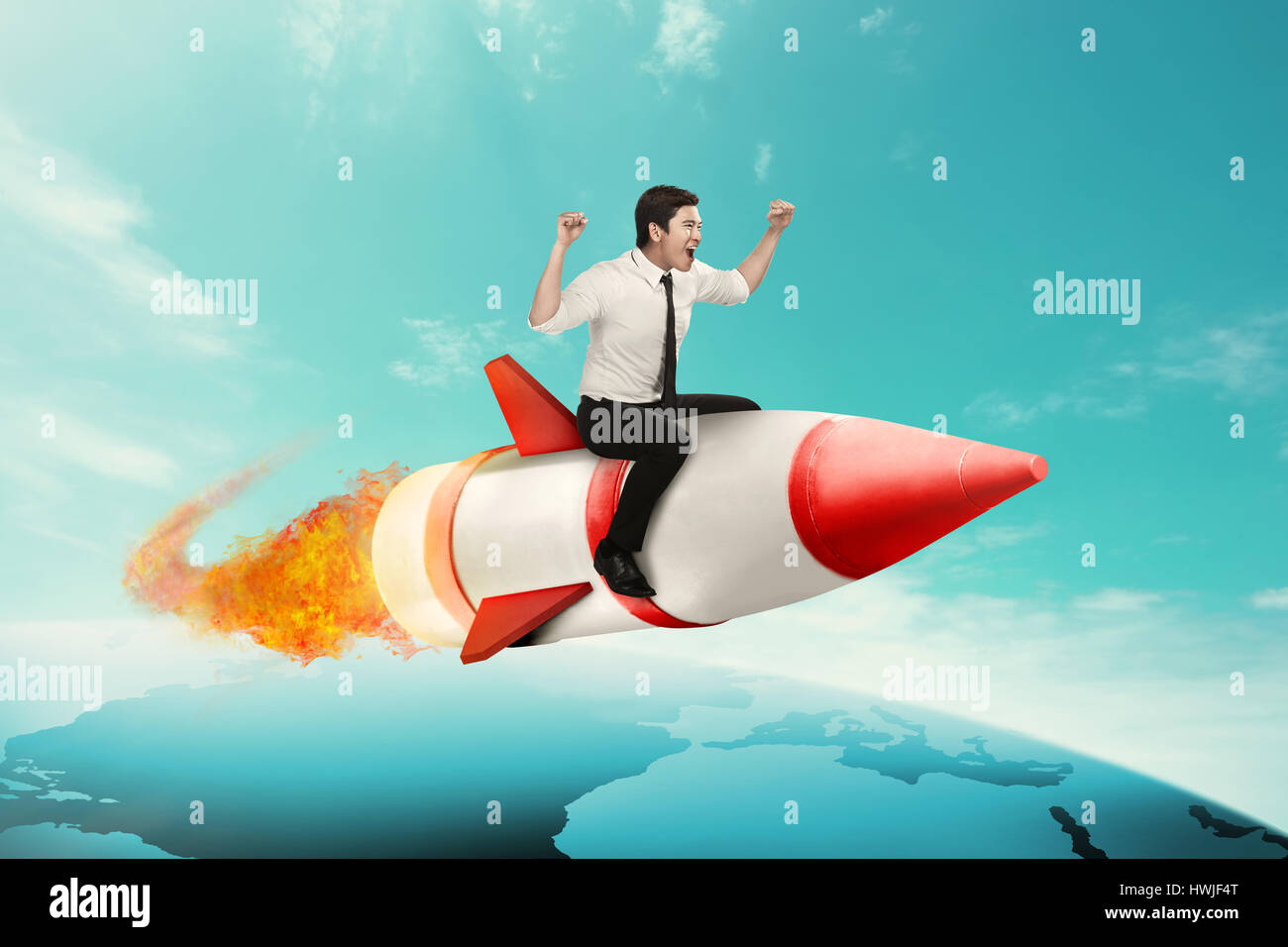 Asian business man riding rocket across the earth Stock Photo - Alamy