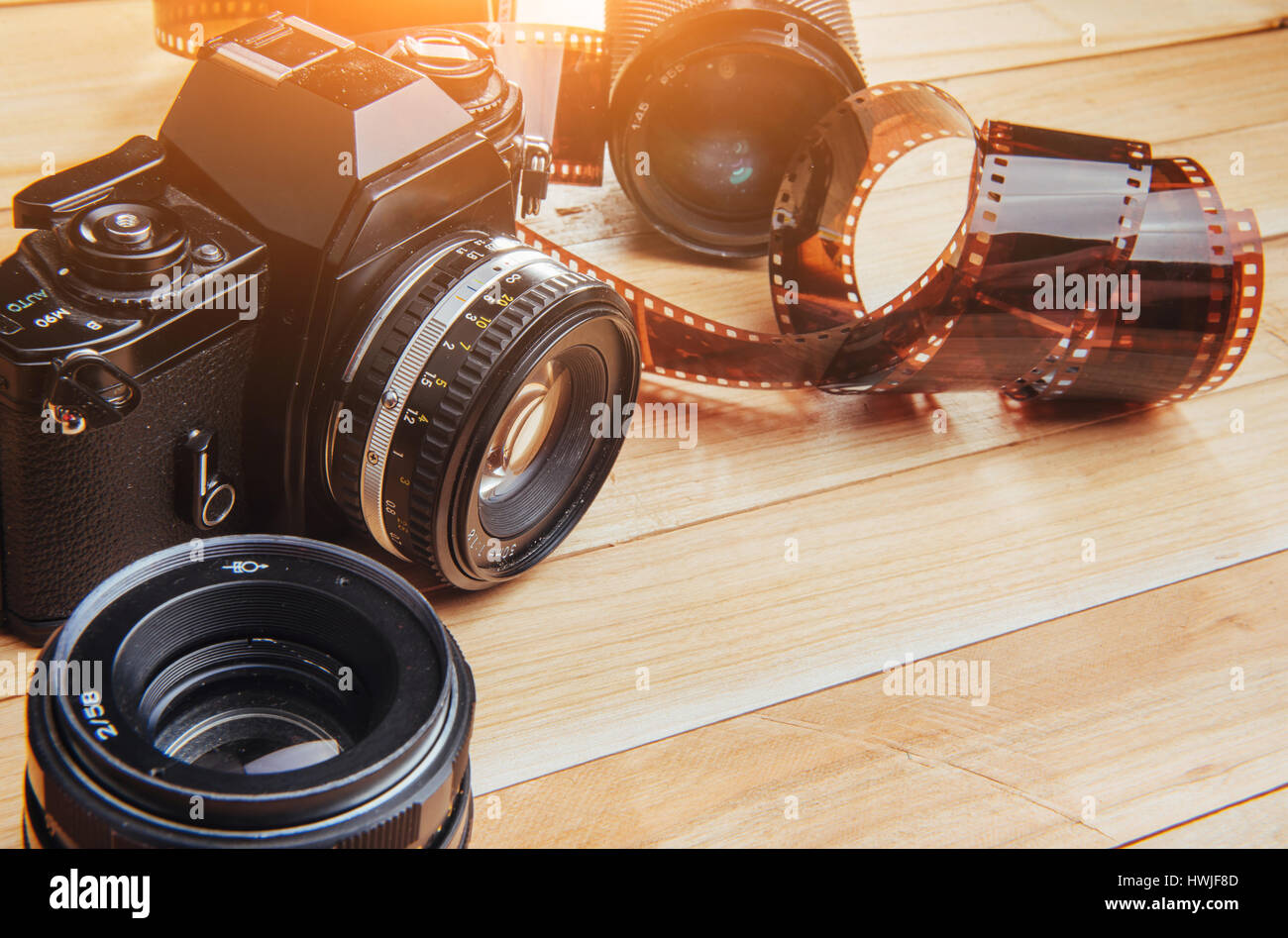Old film camera and a roll of film on wood Stock Photo - Alamy
